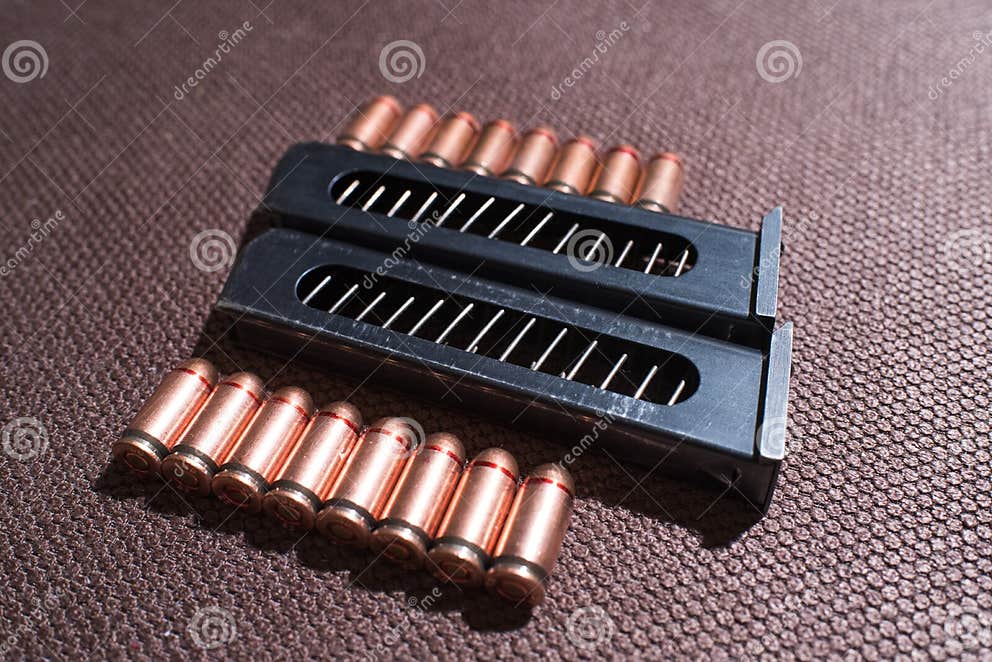 Copper Firearms Bullets and Pistol Clips. Weapon. Stock Photo - Image ...