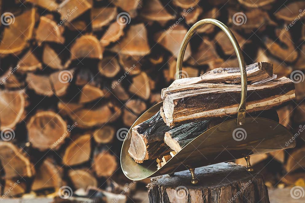 Copper Stack on Tree Stump in Front of Stacked Firewood Stock Photo ...