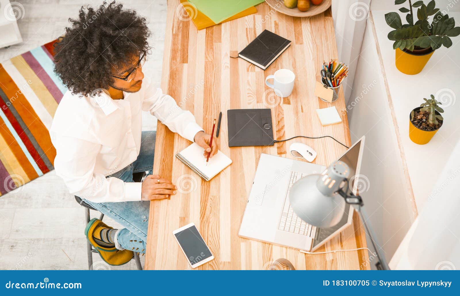 Copywriter Working from Home. Creative Young Man Writes Notes in Note ...