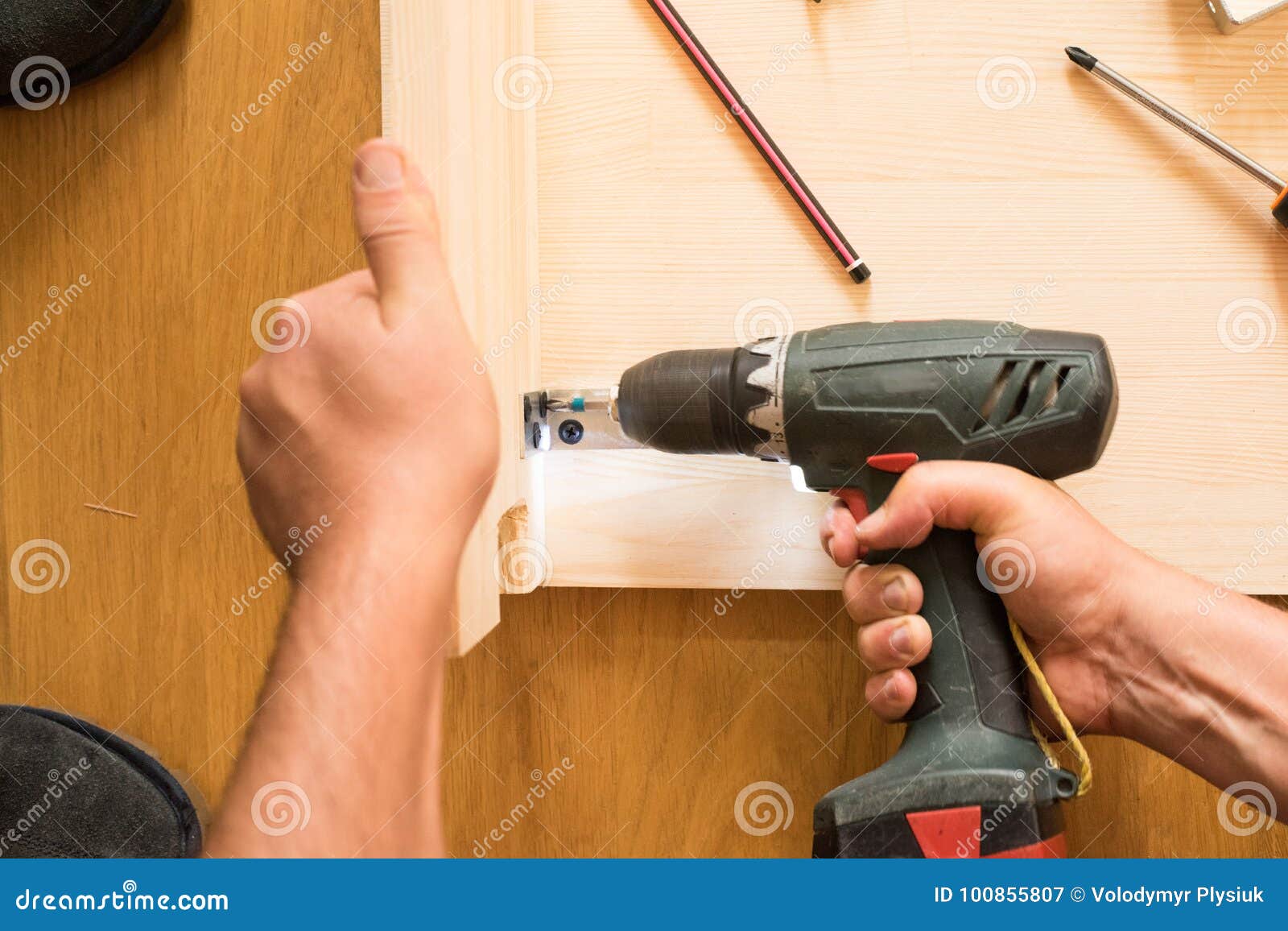 Cordless screwdriver using stock image. Image of carpenter - 100855807
