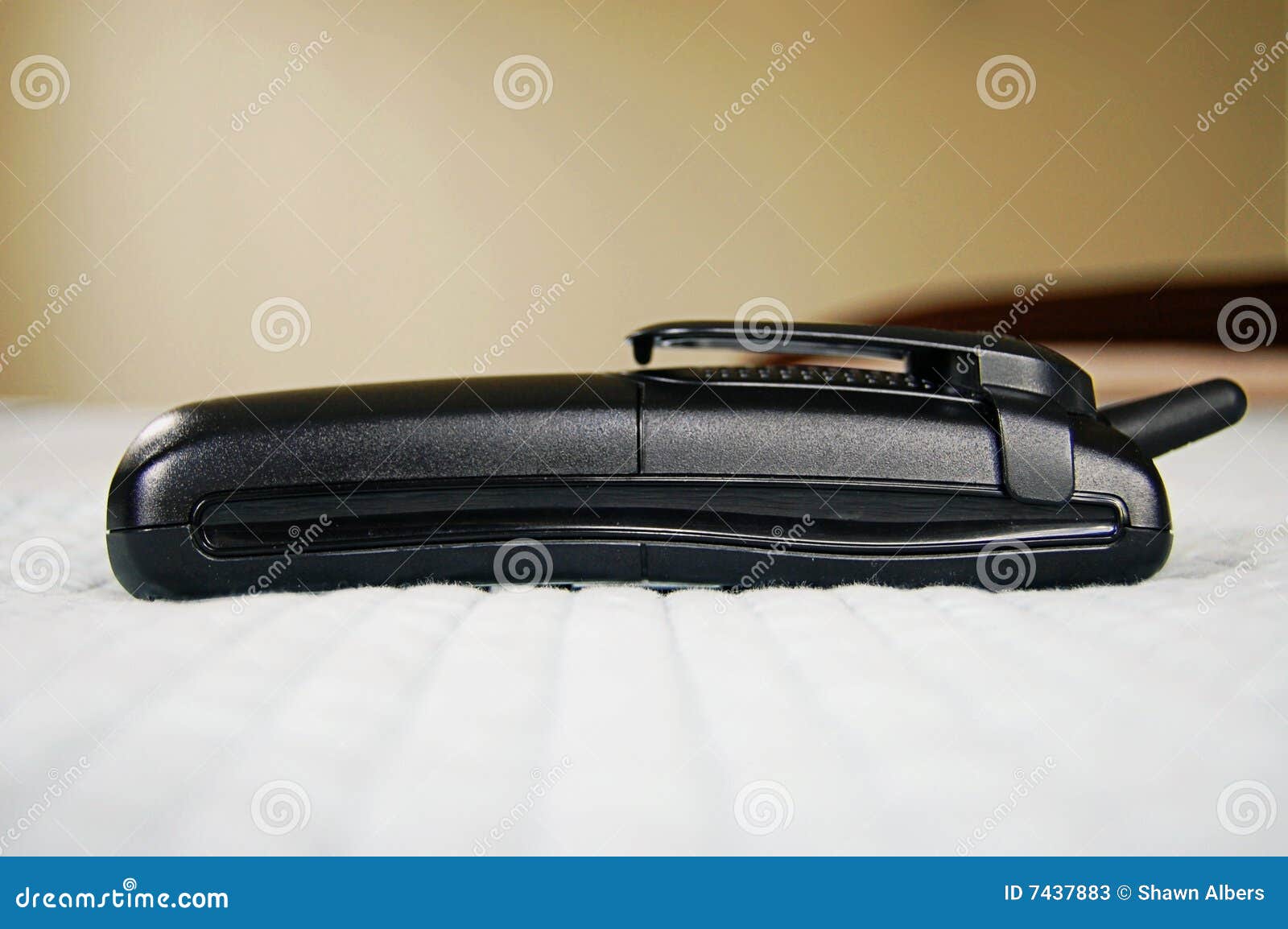 Cordless telephone on bed stock image. Image of message - 7437883