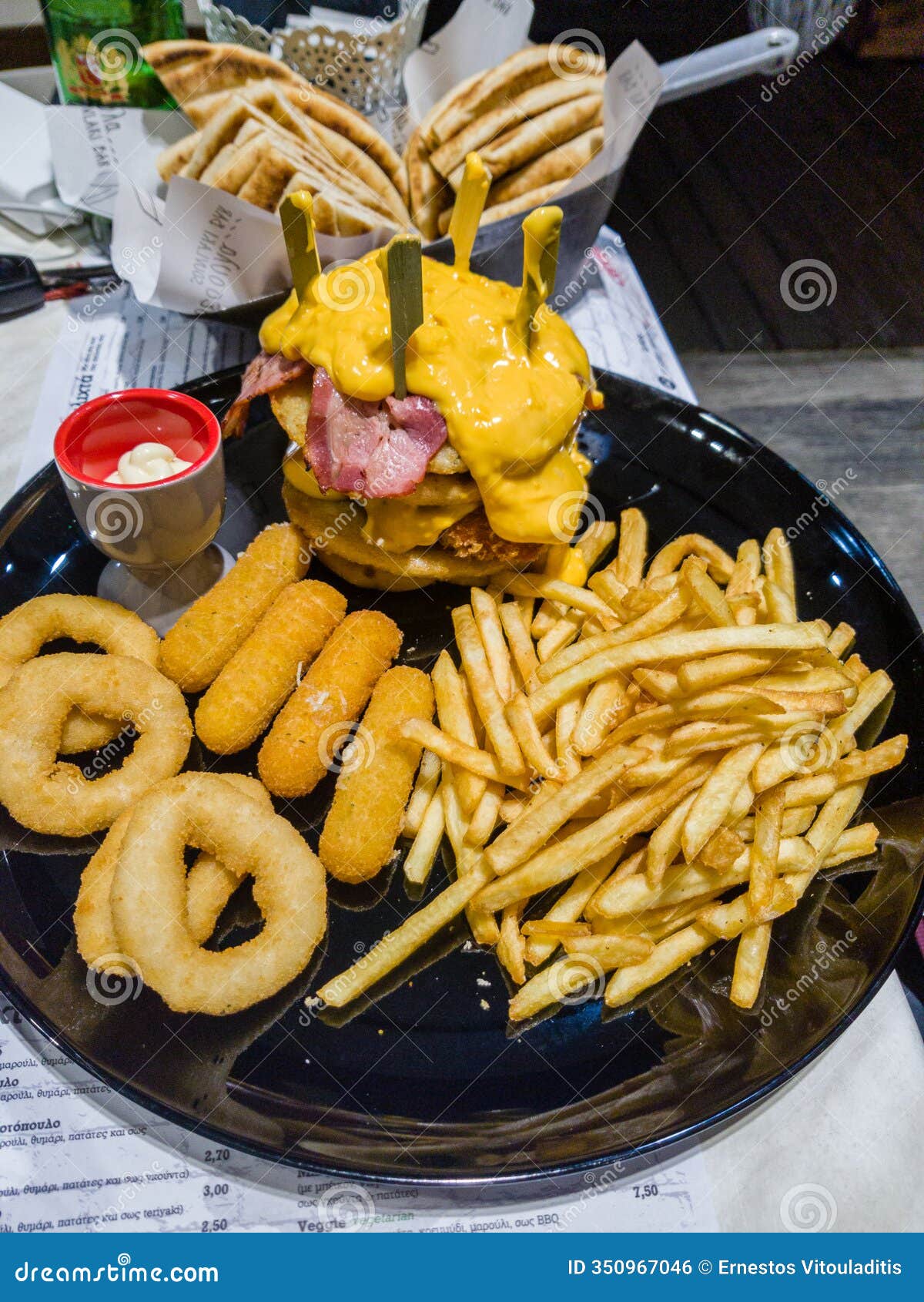 Loaded Burger with Cheese, Bacon, and Sides Editorial Photo - Image of ...