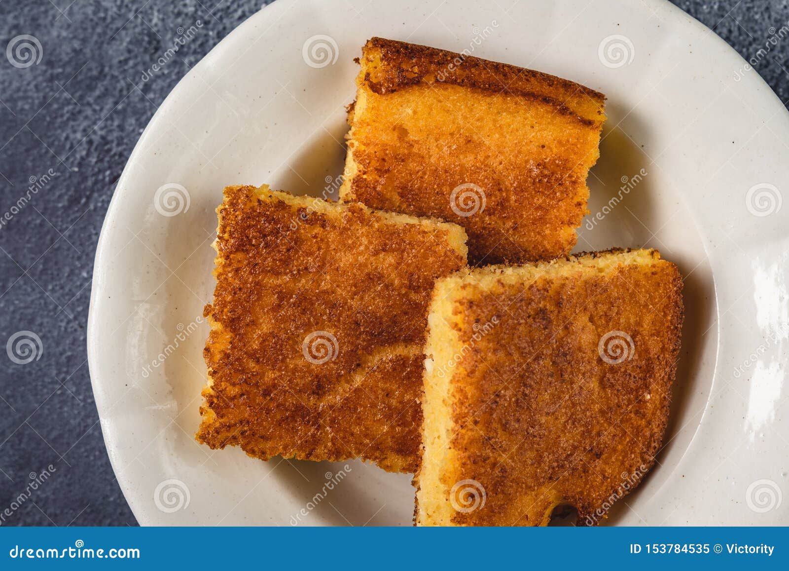 Corn Bread Squares Slices in White Plate on Dark Blue Background Stock ...