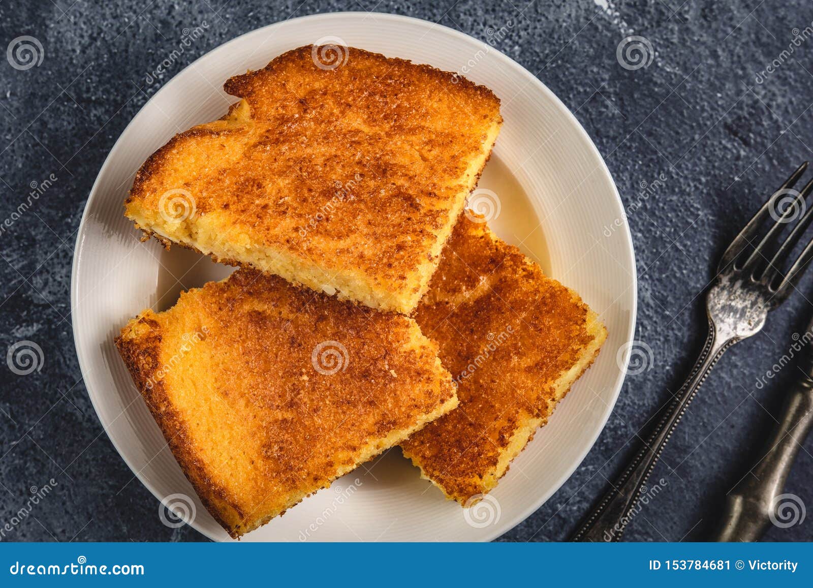 Corn Bread Squares Slices in White Plate on Dark Blue Background Stock ...