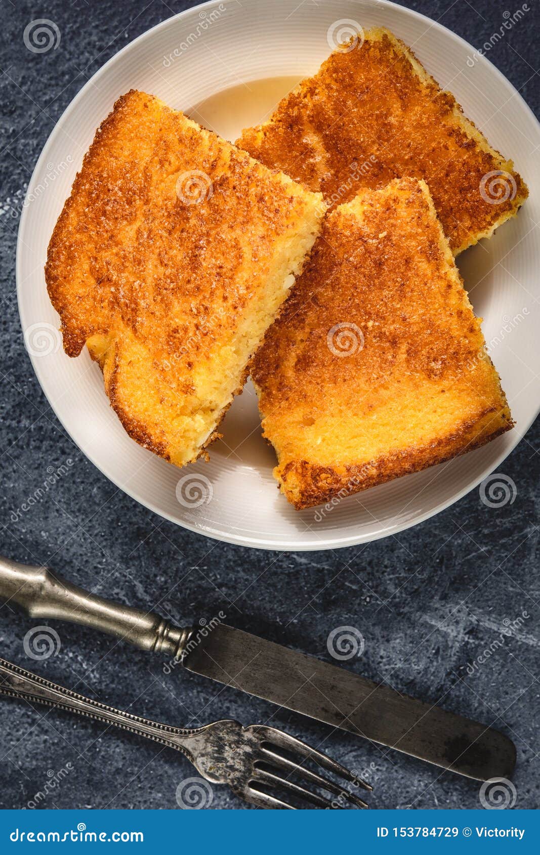 Corn Bread Squares Slices in White Plate on Dark Blue Background Stock ...