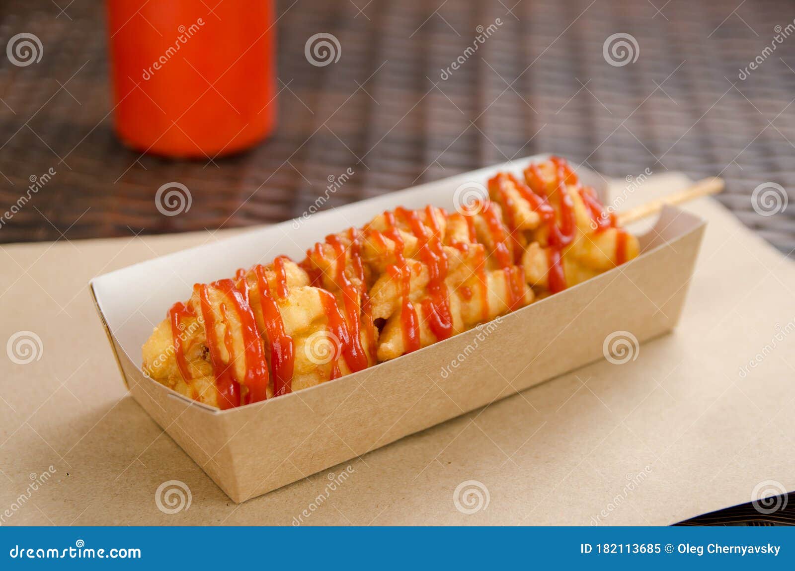 Corn Dog with Ketchup in a Box Next To Ketchup Bottle Stock Image ...