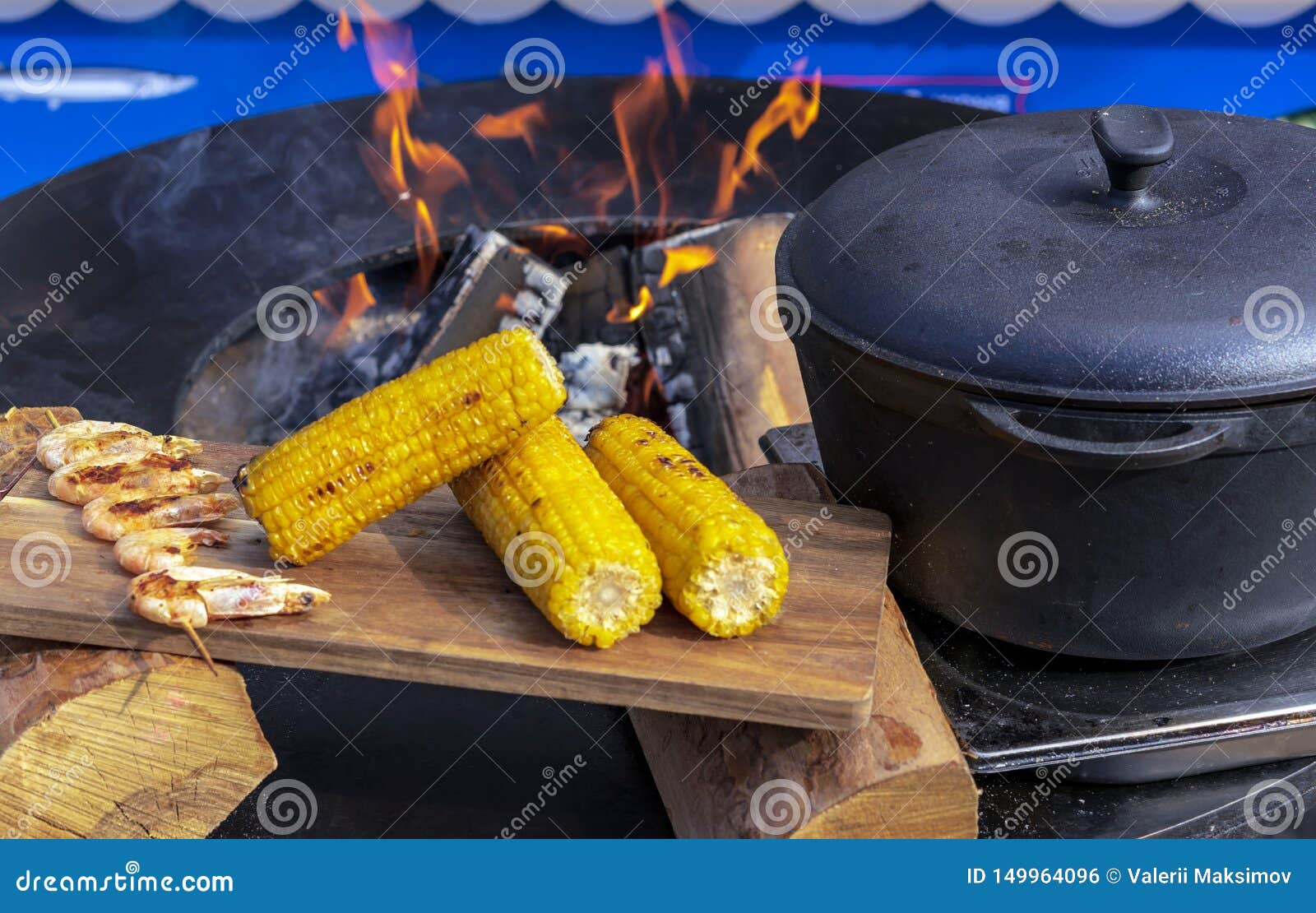 Corn, Shrimp and Cast-iron Cauldron Next To the Round Grill Stock Photo ...