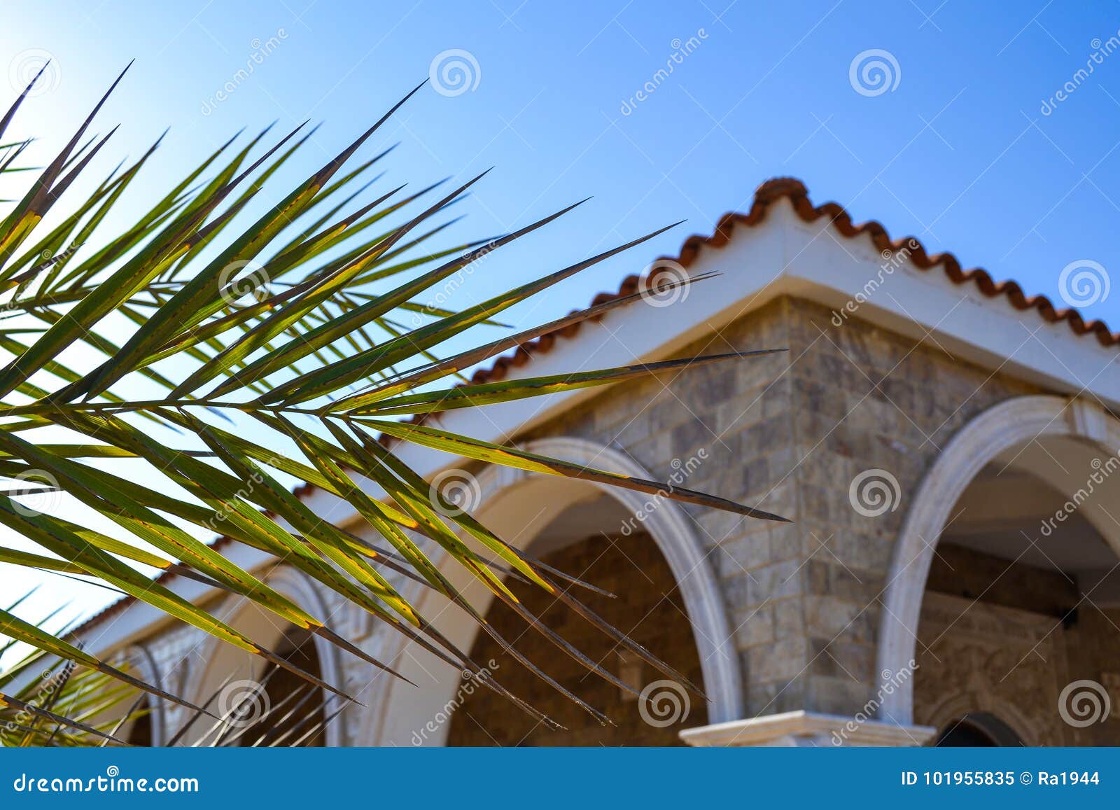 The Corner of the Building with Arches and a Tiled Roof. Stock Image ...