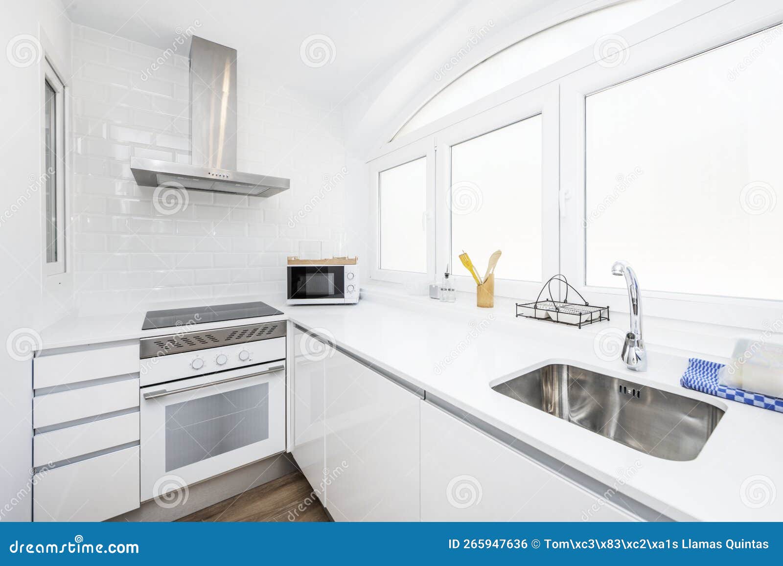 Corner of a Kitchen with a Large Window, White Stone Countertops and ...