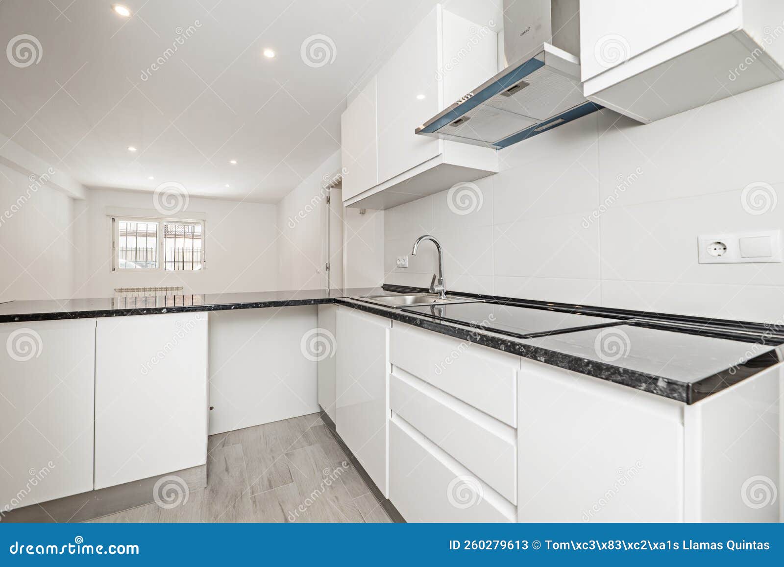Corner of a Kitchen with White Cabinets and a Black Countertop Stock ...