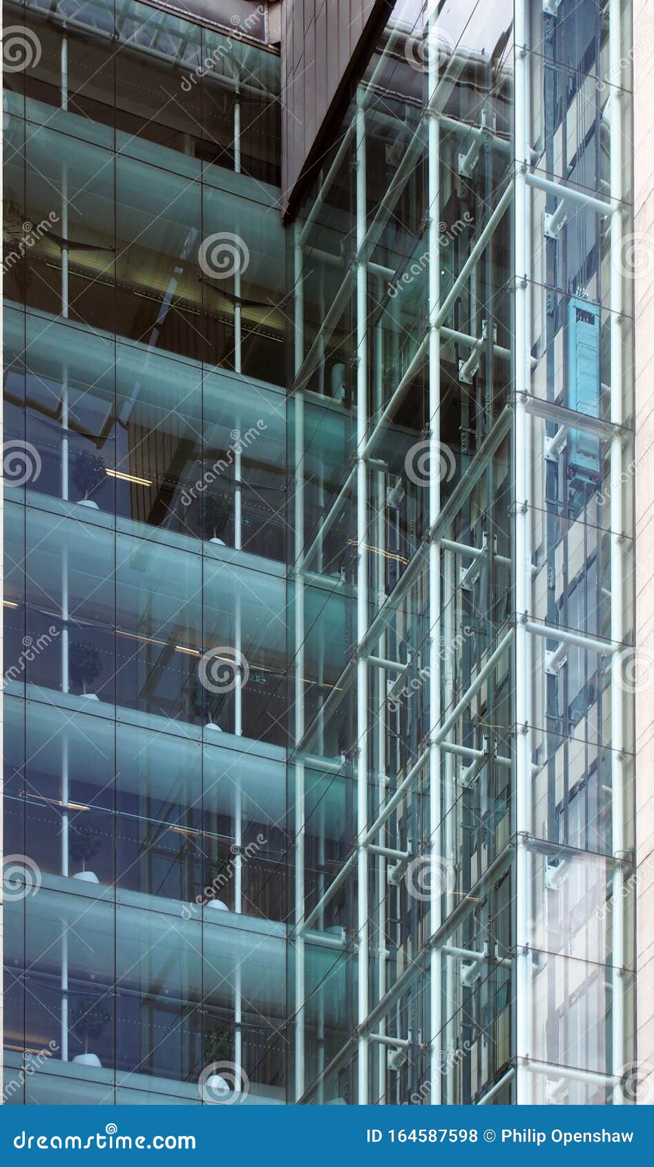 Corner View of Elevators and Stories in a Tall Modern Glass Corporate ...