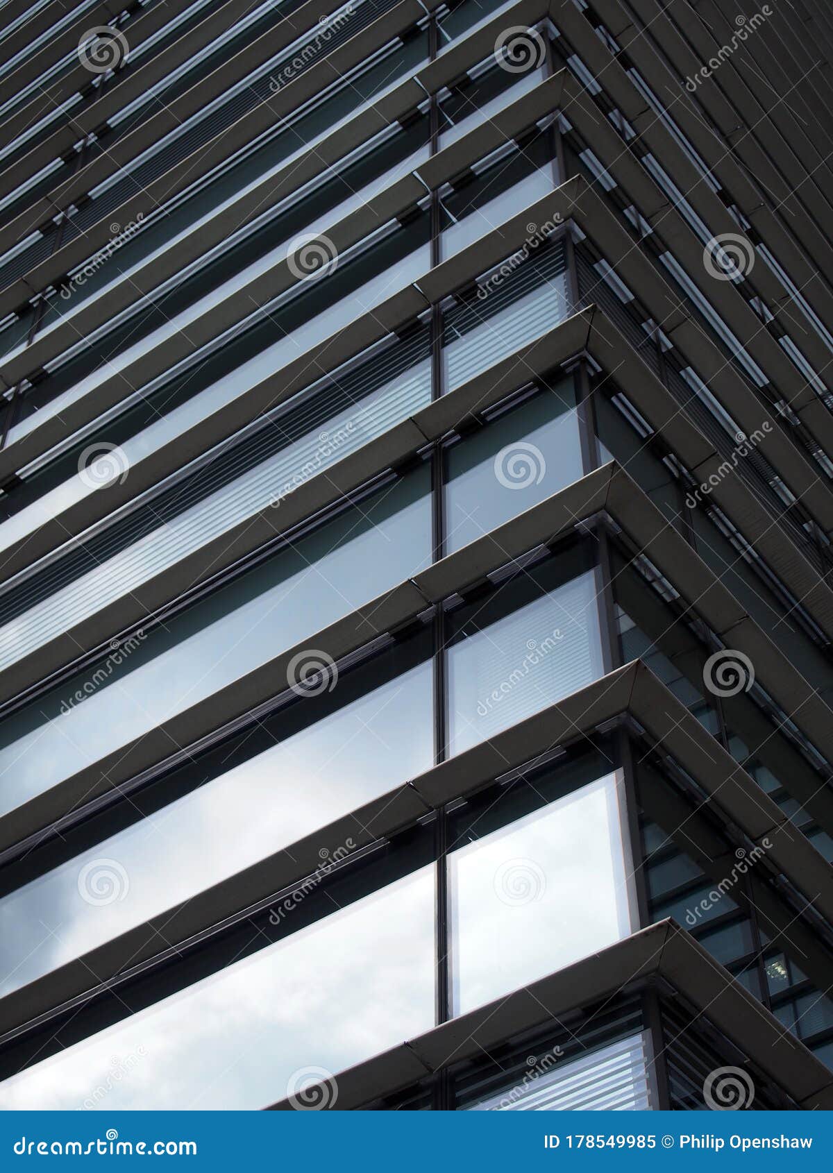 Corner View of a Modern Futuristic Office Building with Blue Sky and ...