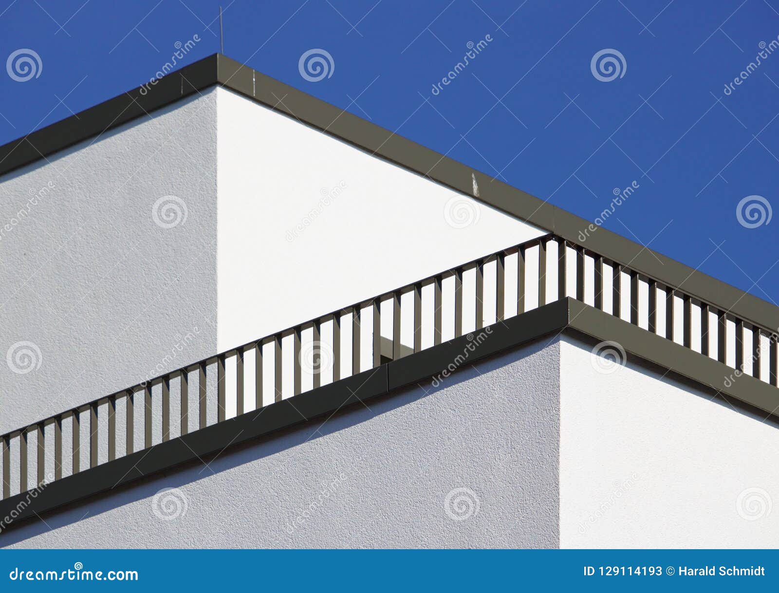 Corner of a White Building with Diagonal Balcony Railing and Blue Sky ...