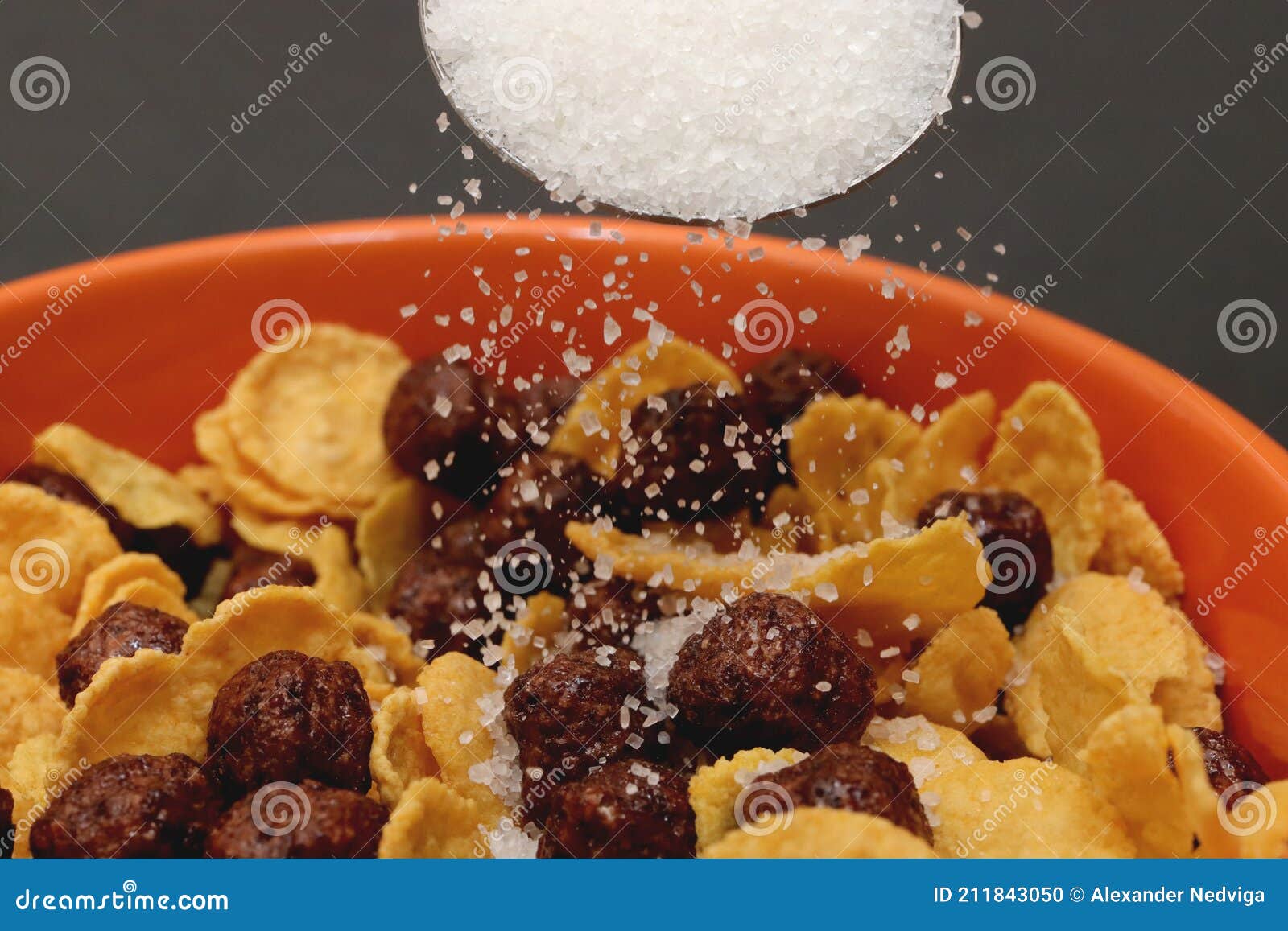 Cornflakes with Chocolate Balls in Bowl with Pouring Sugar Stock Photo ...