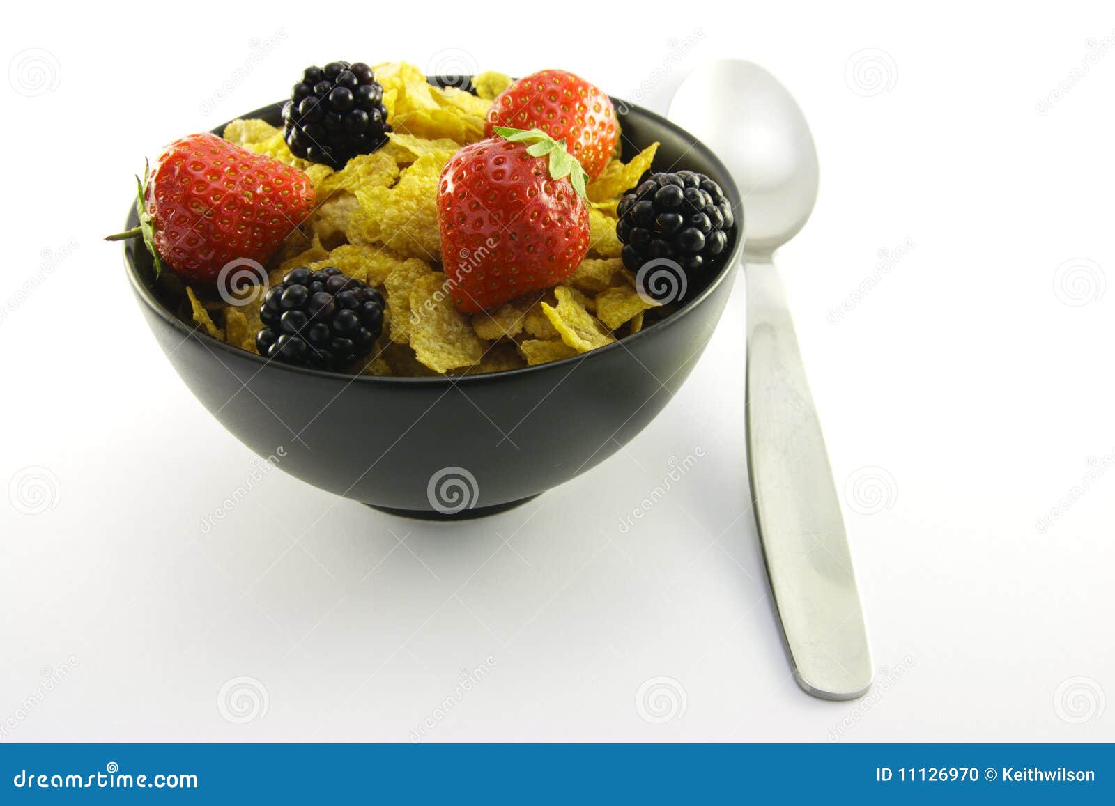 Cornflakes and Fruit in a Black Bowl with a Spoon Stock Photo - Image ...