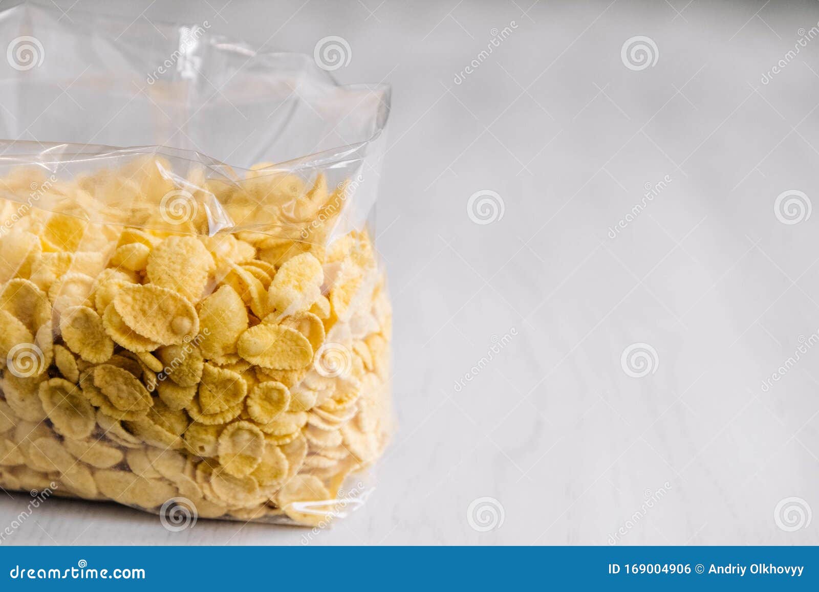Cornflakes in Plastic Bag on White Wooden Surface. Place for Your Text ...