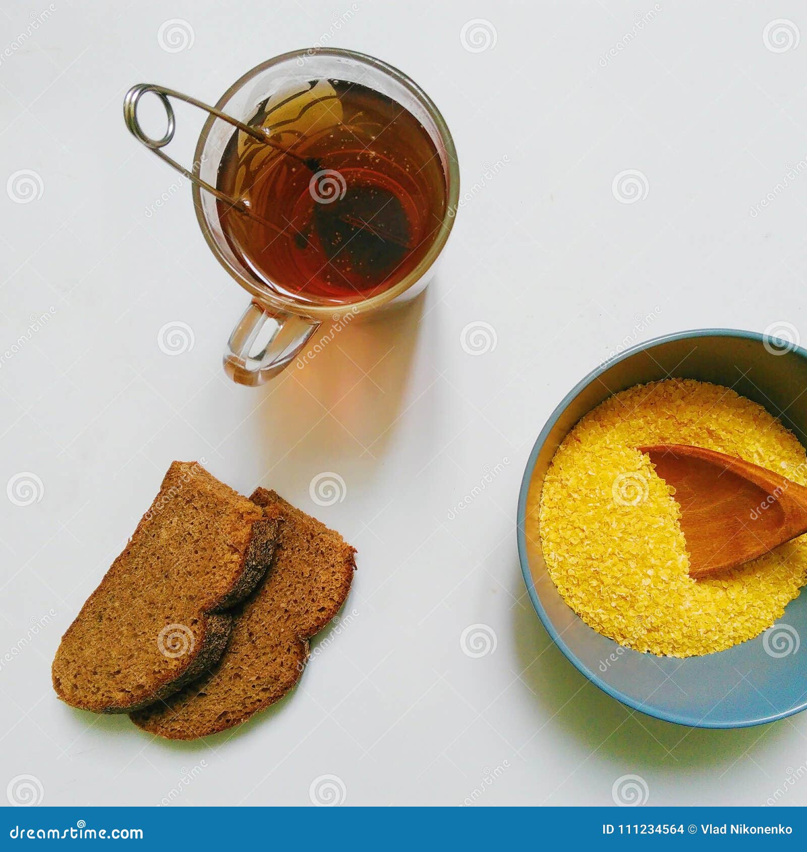 Cornflakes in a Plate, a Cup of Black Tea and Two Slices of Bread on a ...