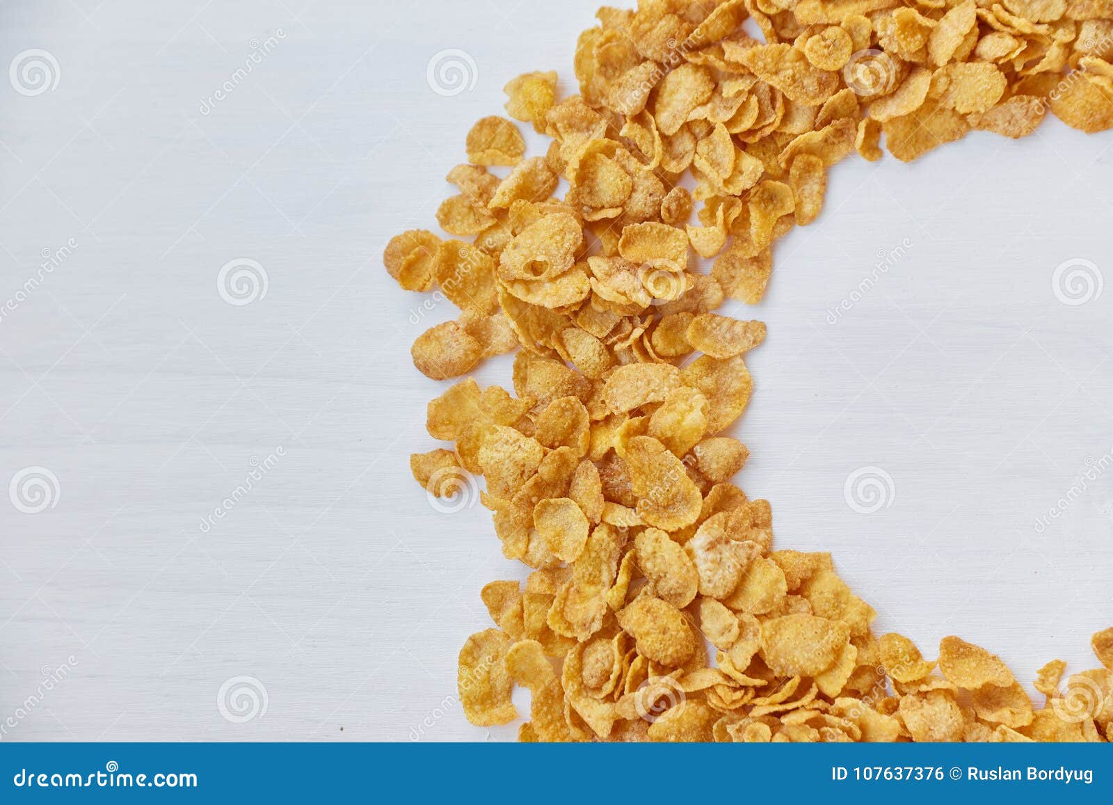 Round Frame Lined with Corn Flakes. Cornflakes Scattered on a Wooden ...