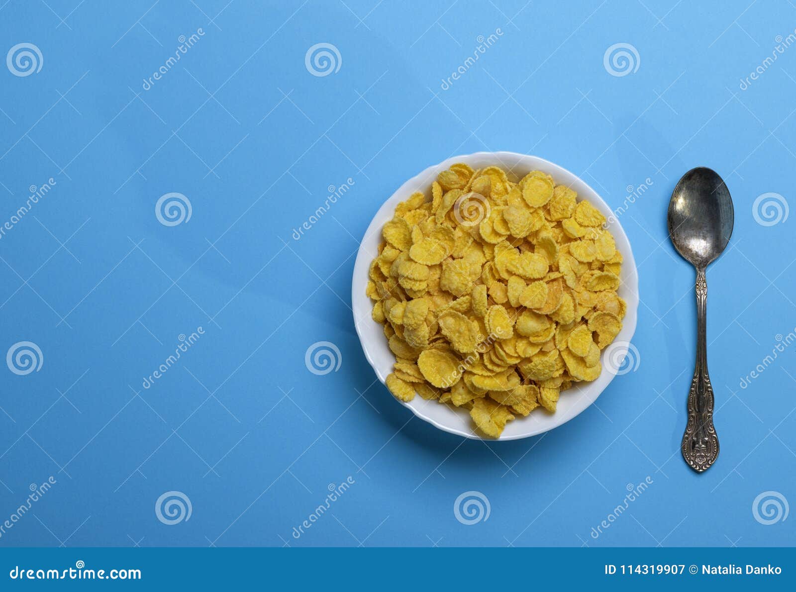 Cornflakes in a White Ceramic Plate and an Iron Spoon Stock Image ...