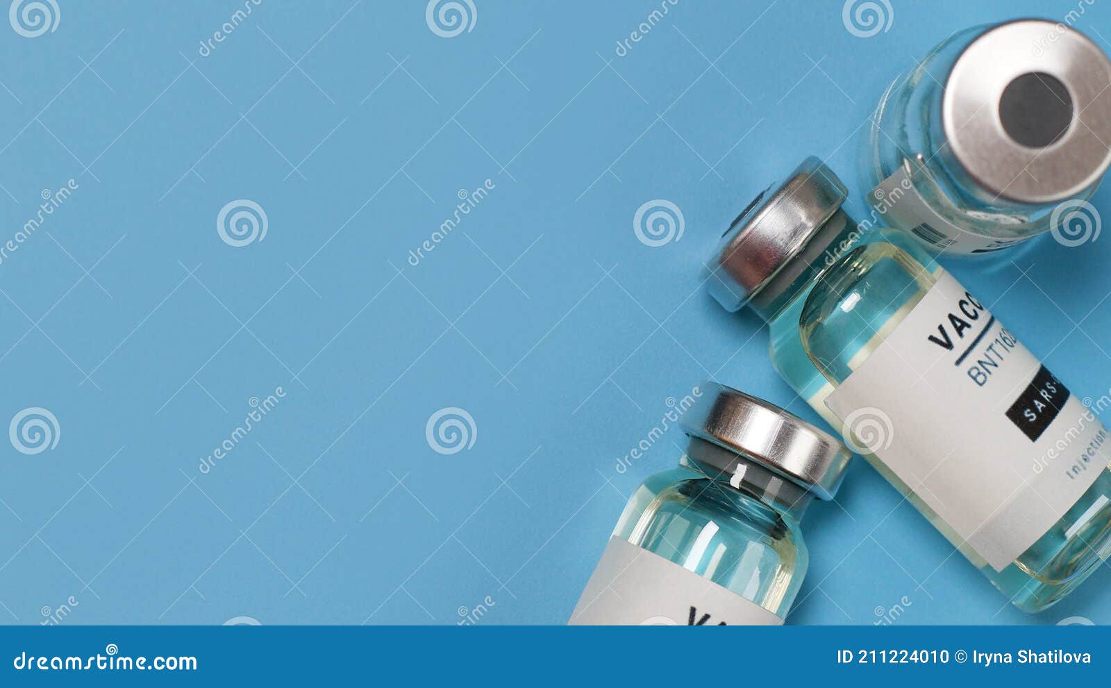 Coronavirus Covid-19 Experimental Vaccine Vials on Blue Table with ...