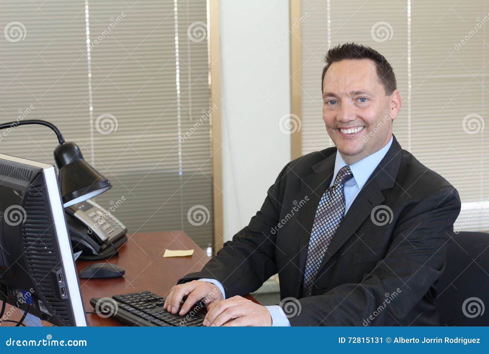 Corporate Businessman Working with Computer in Office, Looking at ...