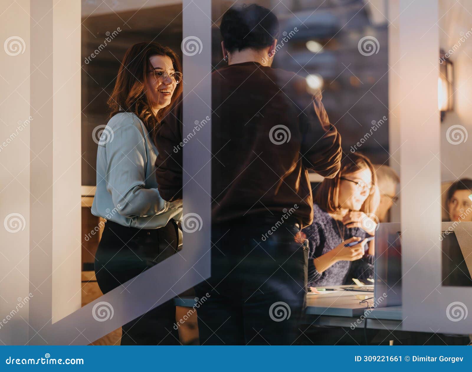Corporate Team Working Late Hours in Modern Office Environment. Stock ...