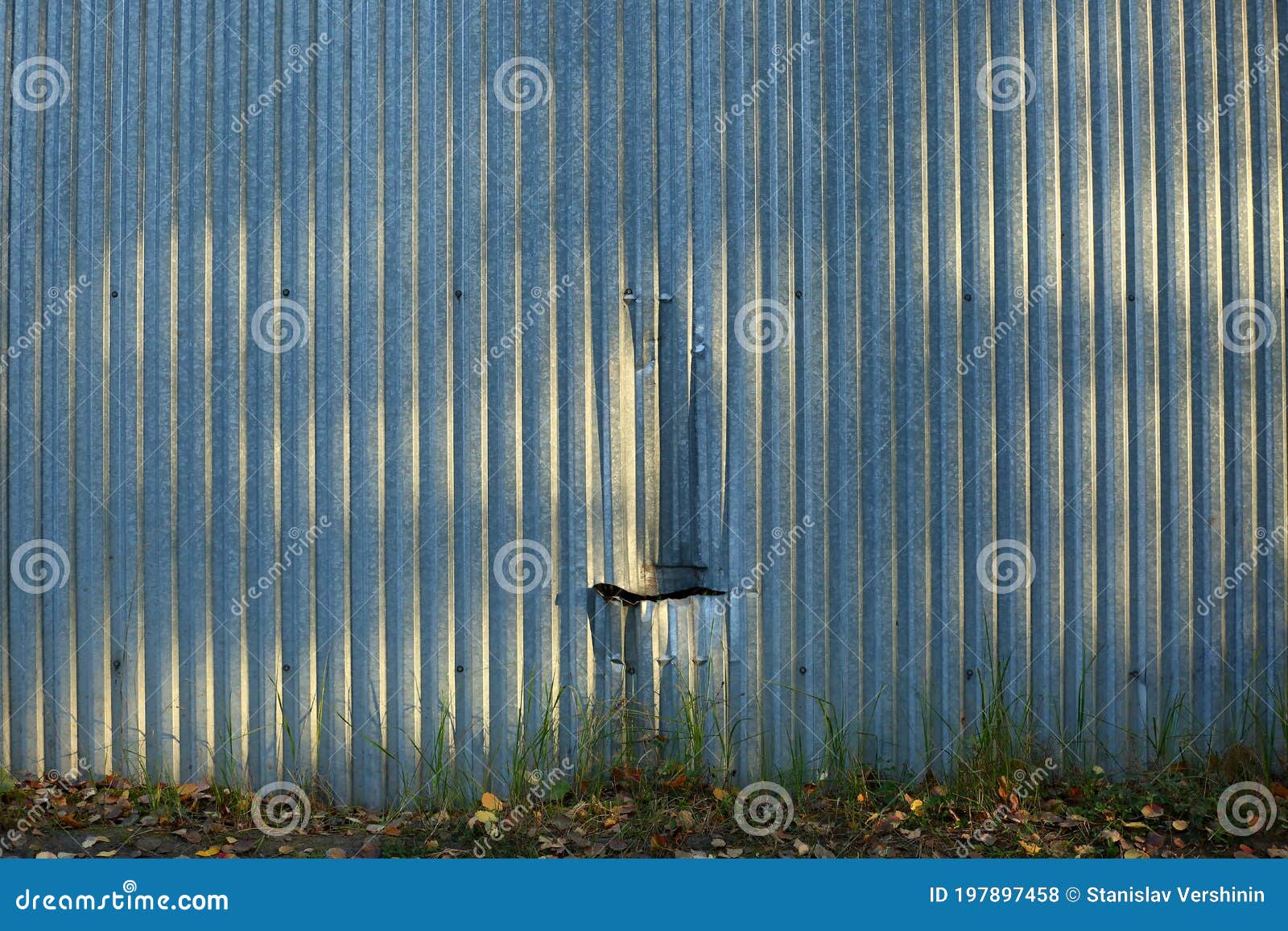 Corrugated Metal Fence With A Dent And A Ragged Hole Royalty-Free Stock ...