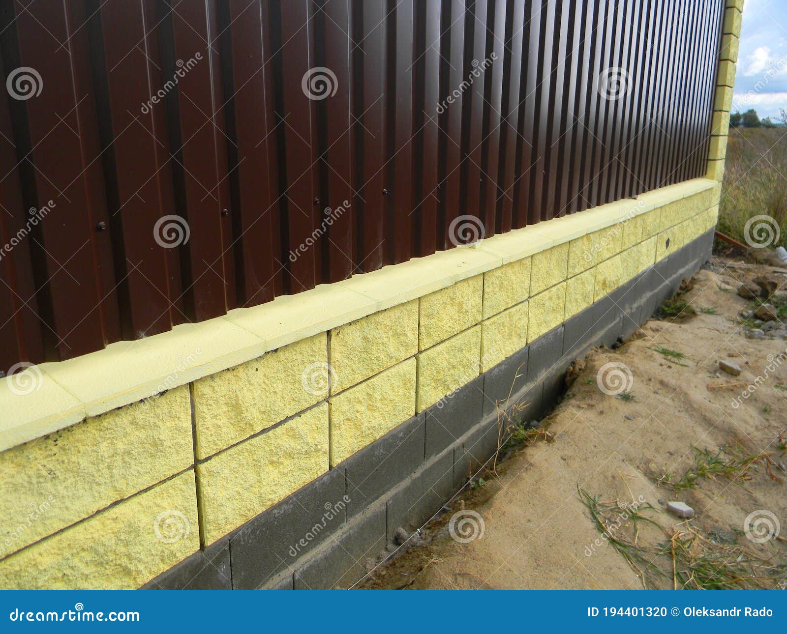 Corrugated Metal Panel Fence Installation on the Brick Foundation in a ...