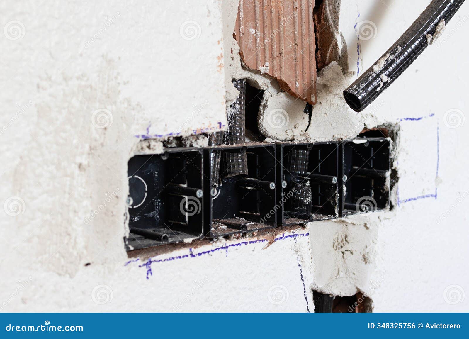 Electrician Installing Electrical Outlets in Wall during Home ...