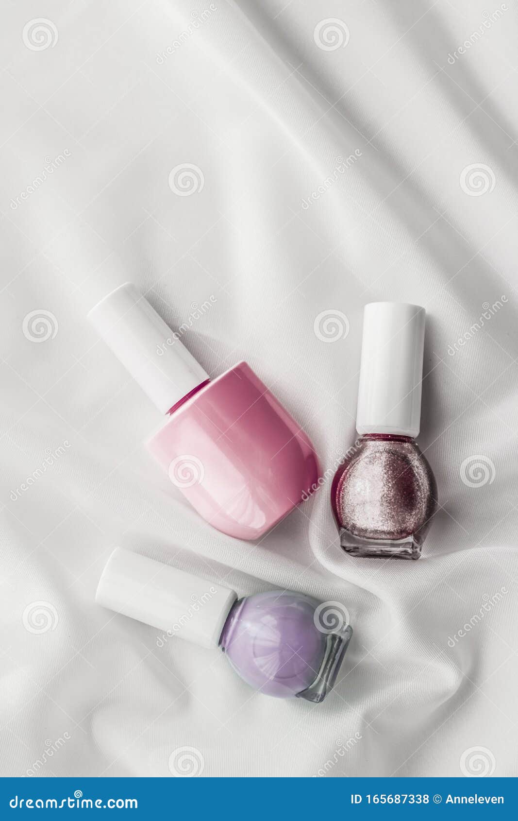 Nail Polish Bottles On Silk Background French Manicure Products And