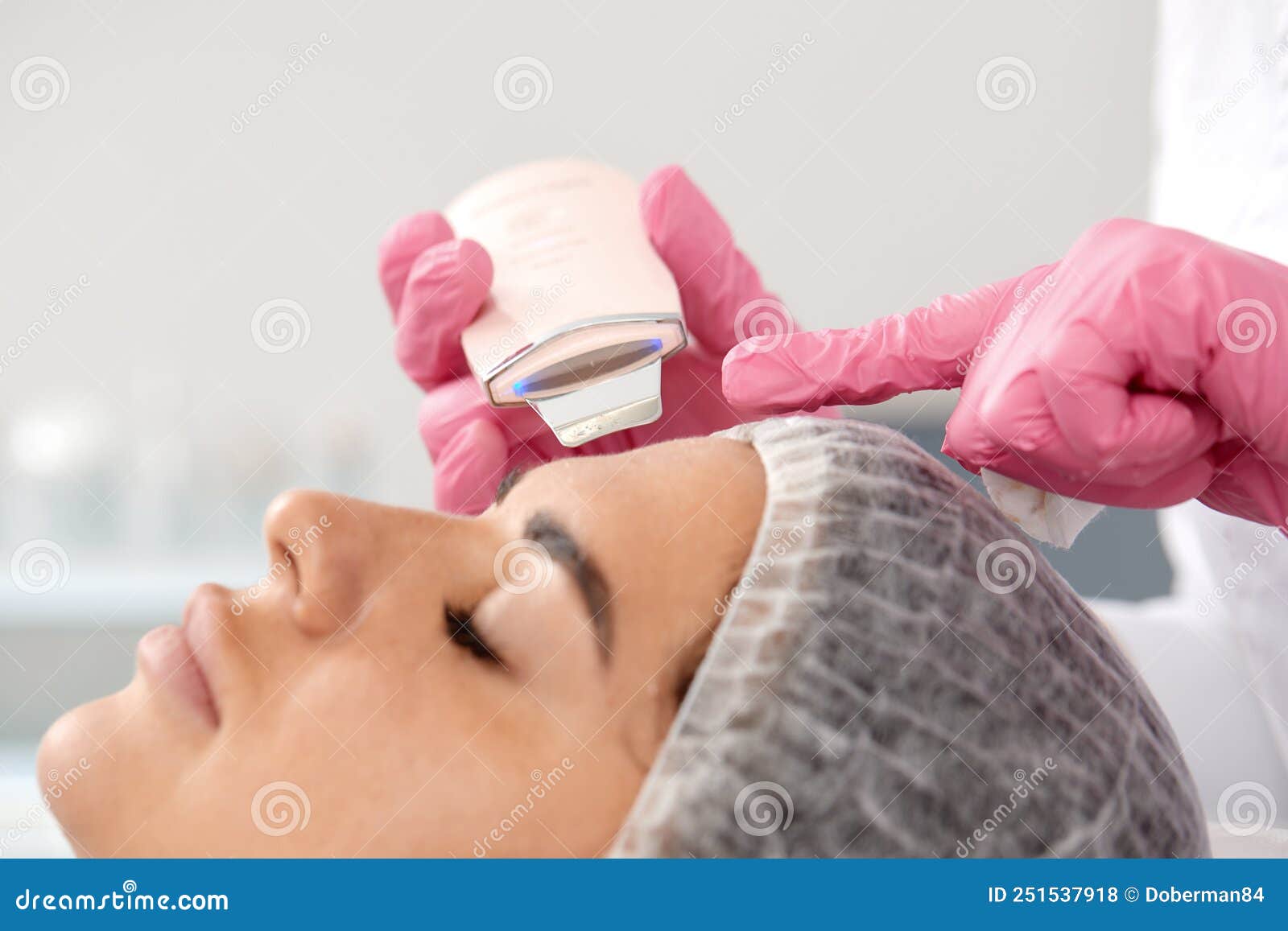 Cosmetologist Beautician In Pink Gloves Making Facial Treatment With