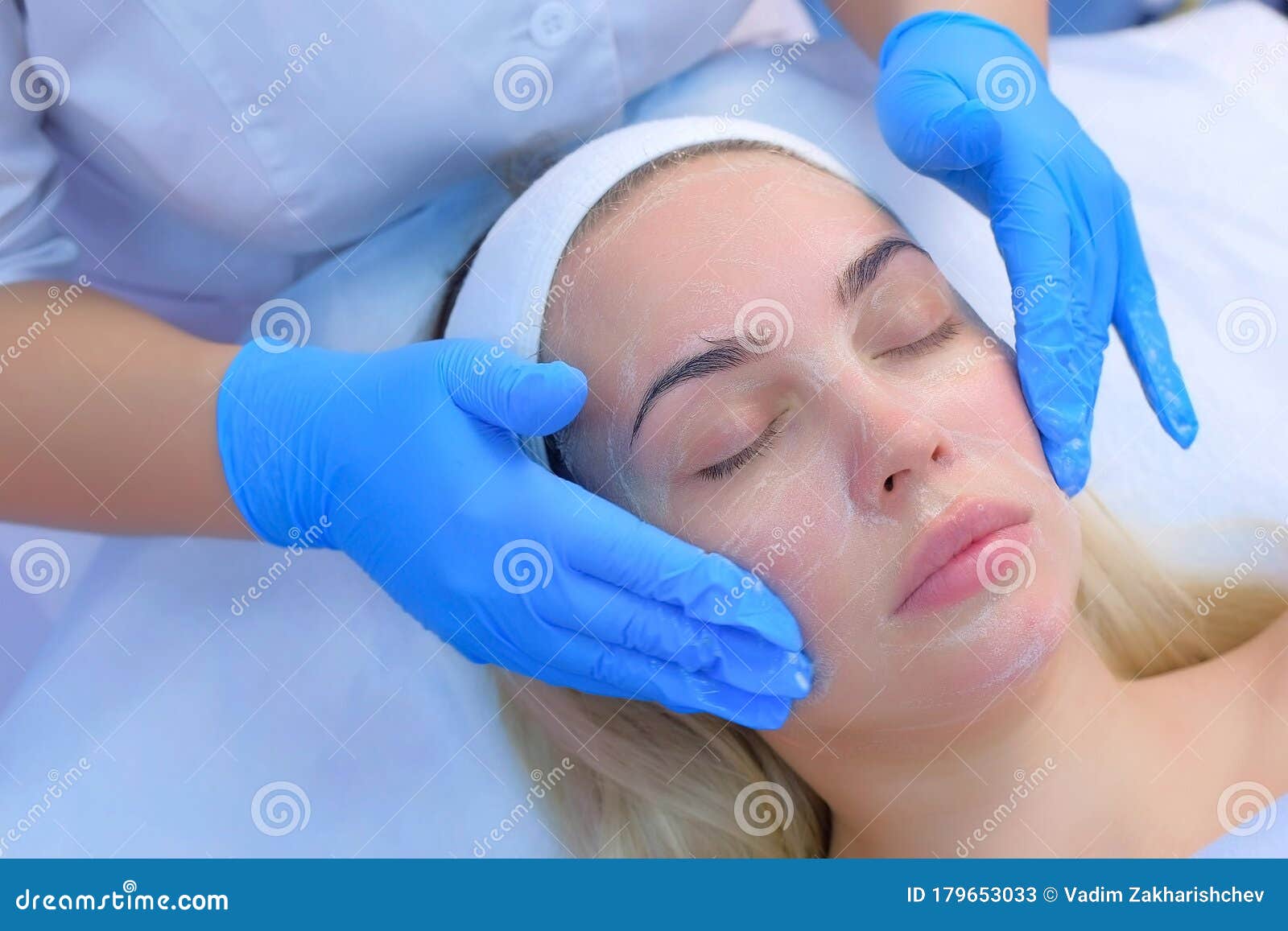 Cosmetologist In Gloves Applying Cleansing Foam On Woman`s Face