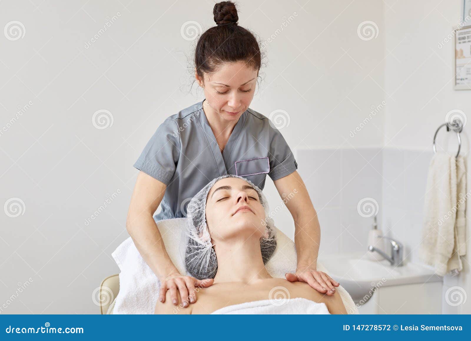 Cosmetologist Looks At Her Client Putting Her Hands On Shoulders