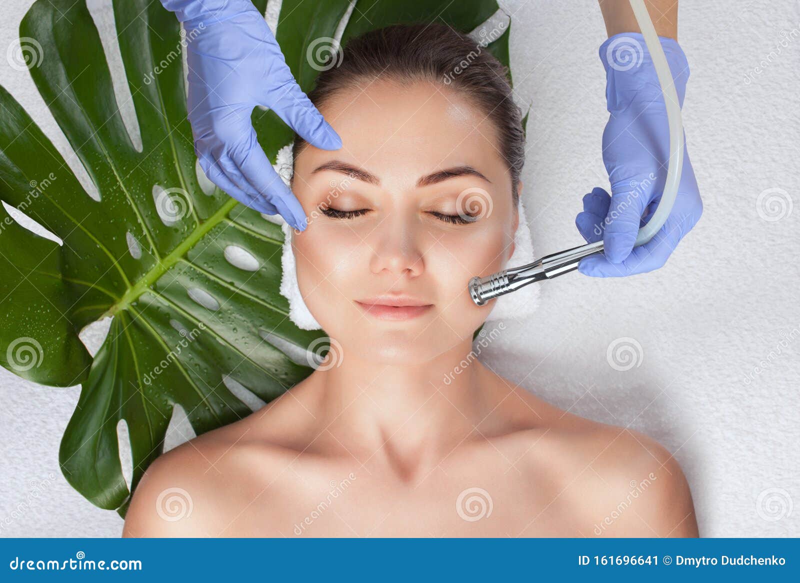 The Cosmetologist Makes The Microdermabrasion Procedure Of The Facial