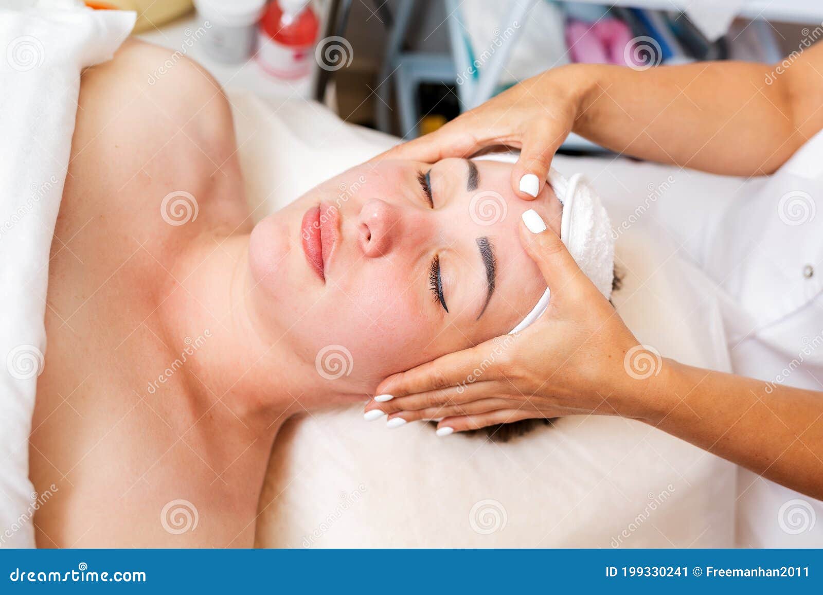 Cosmetologist Massages The Woman`s Face Portrait Of The Client And The