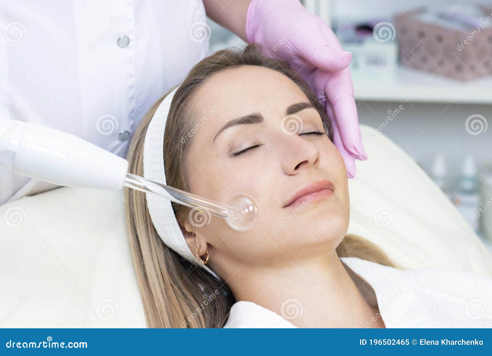 Cosmetologist Performs a Pulse Current Procedure for the Face of a ...