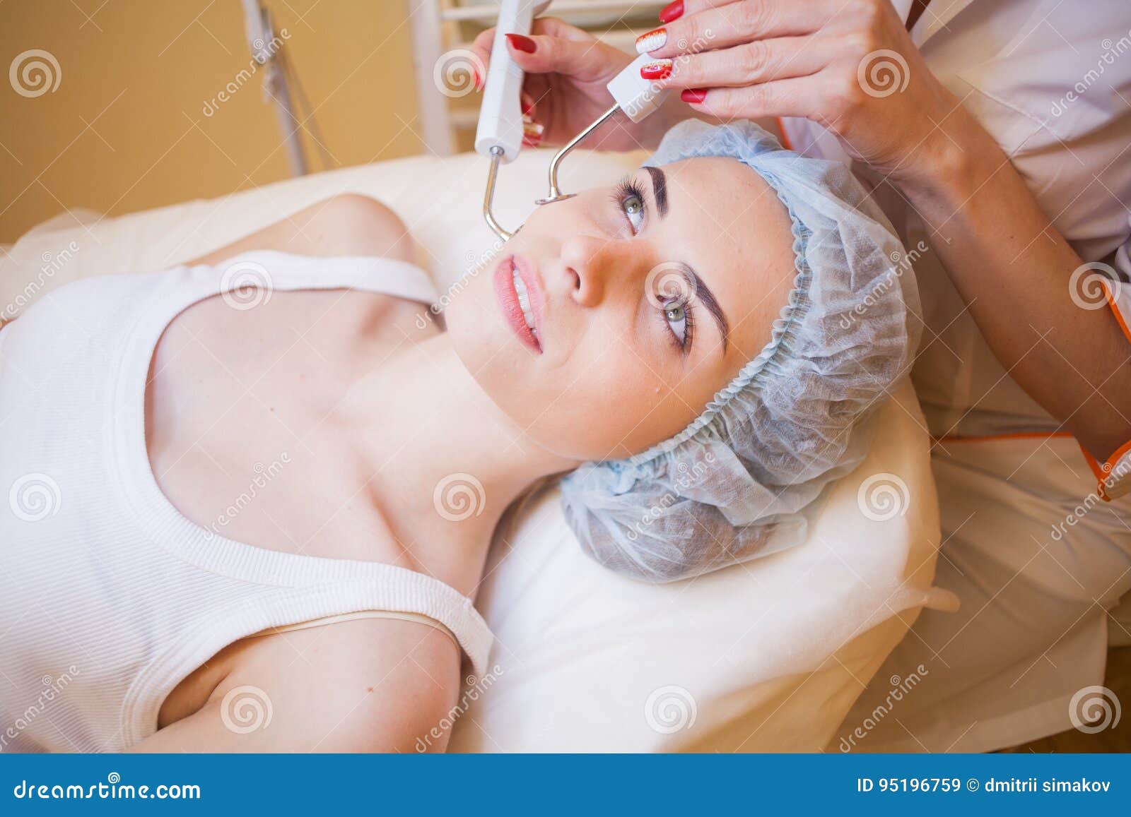 Cosmetology Doctor Makes The Procedure A Woman Face Cleaning Stock