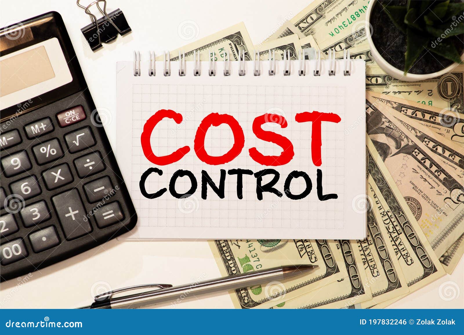 COST CONTROL. Black Notebook and Computer Keyboard on a White Office ...