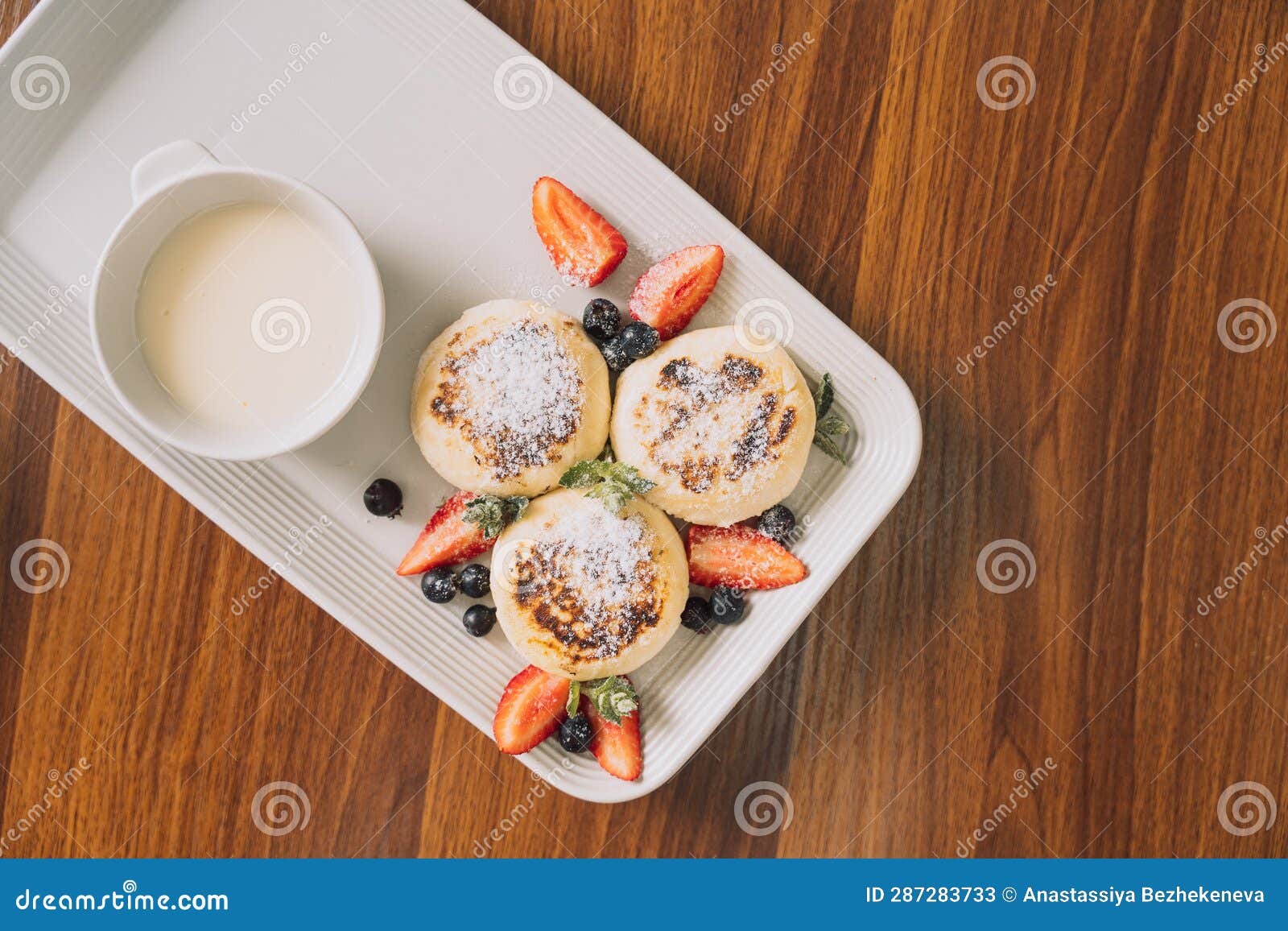 Cottage Cheese Pancakes with Strawberries on a Rectangular Plate with ...