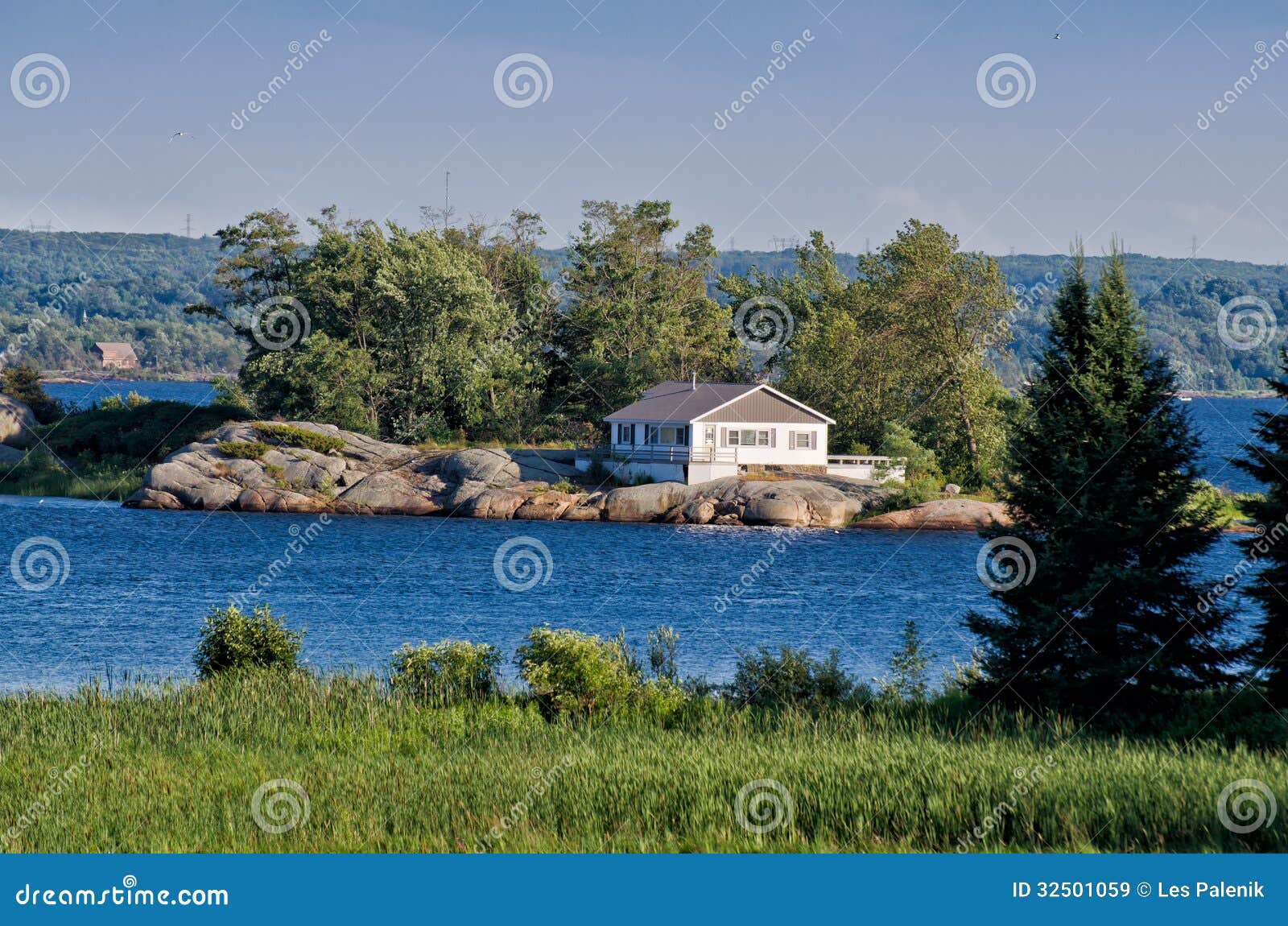 Cottage on a rocky island stock image. Image of island - 32501059