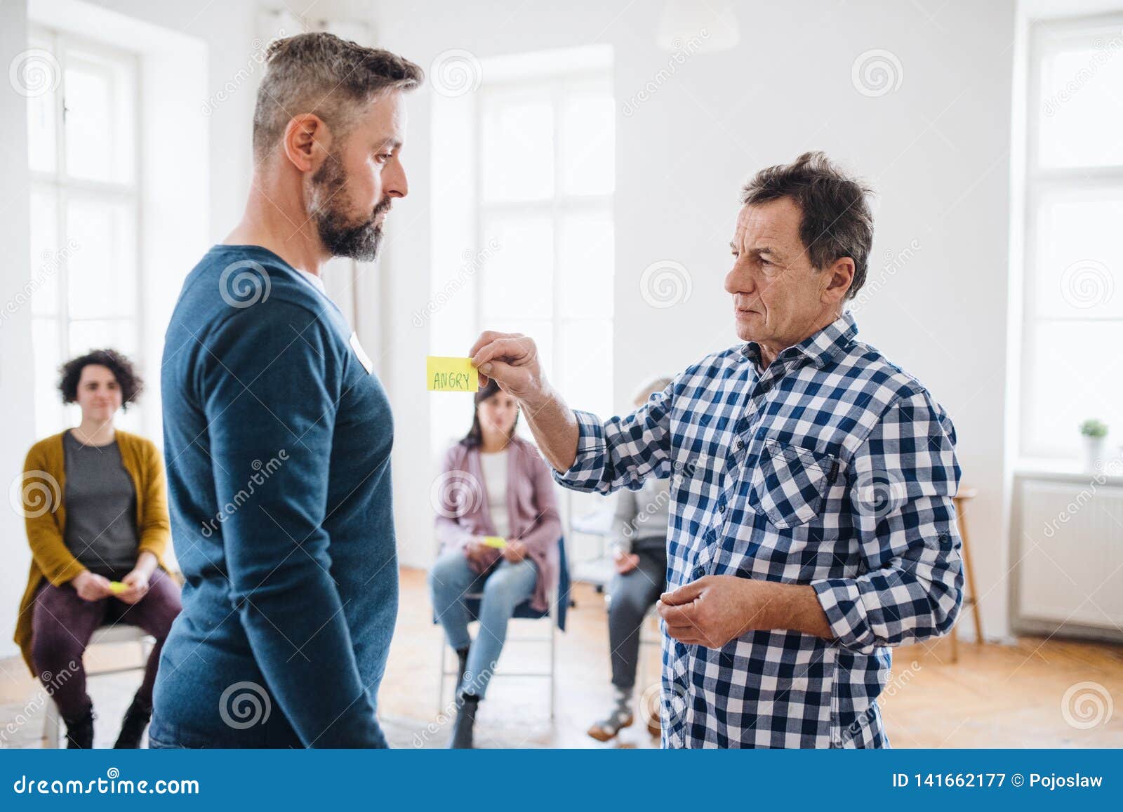 Counsellor Putting an Adhesive Note with the Word Angry on Client ...