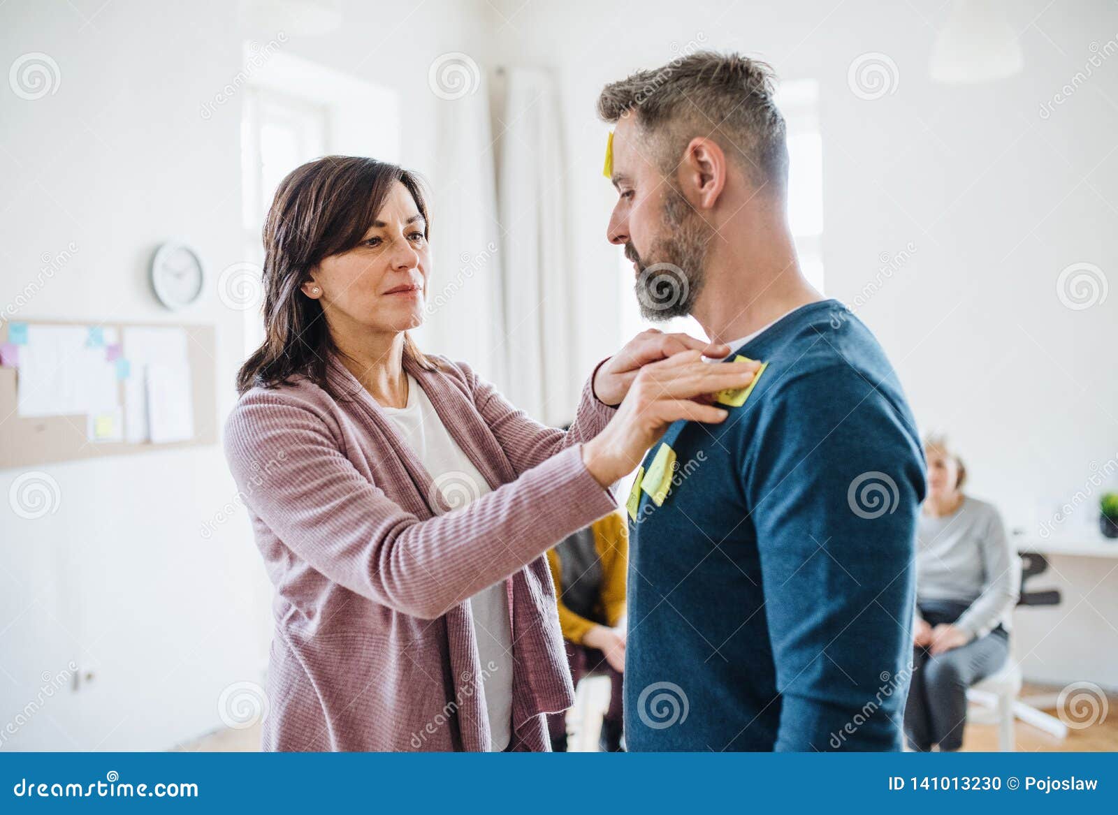 Counsellor Putting an Adhesive Notes on Client during Group Therapy ...