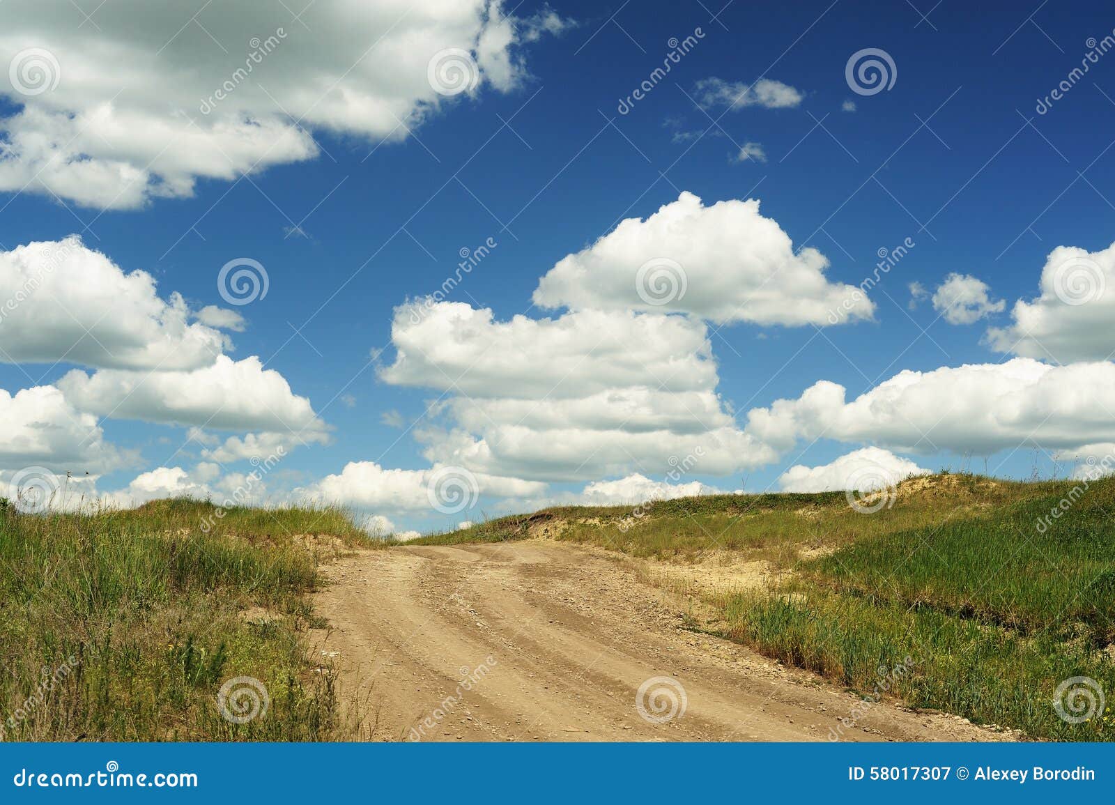 Country Road Ending in Blue Sky with Big Cumulus Clouds Stock Image ...