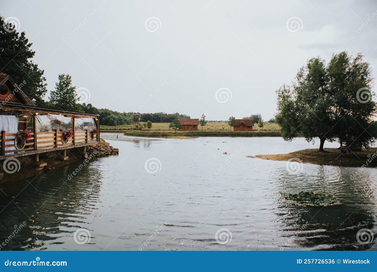 Countryside with Barns by a River on a Cloudy Day Stock Photo - Image ...