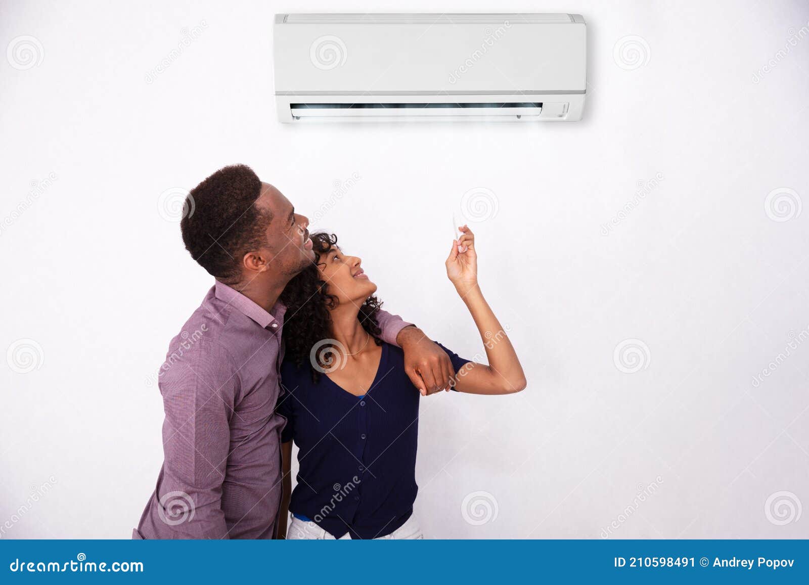 Couple Adjusting Temperature of Air Conditioner Stock Image - Image of ...