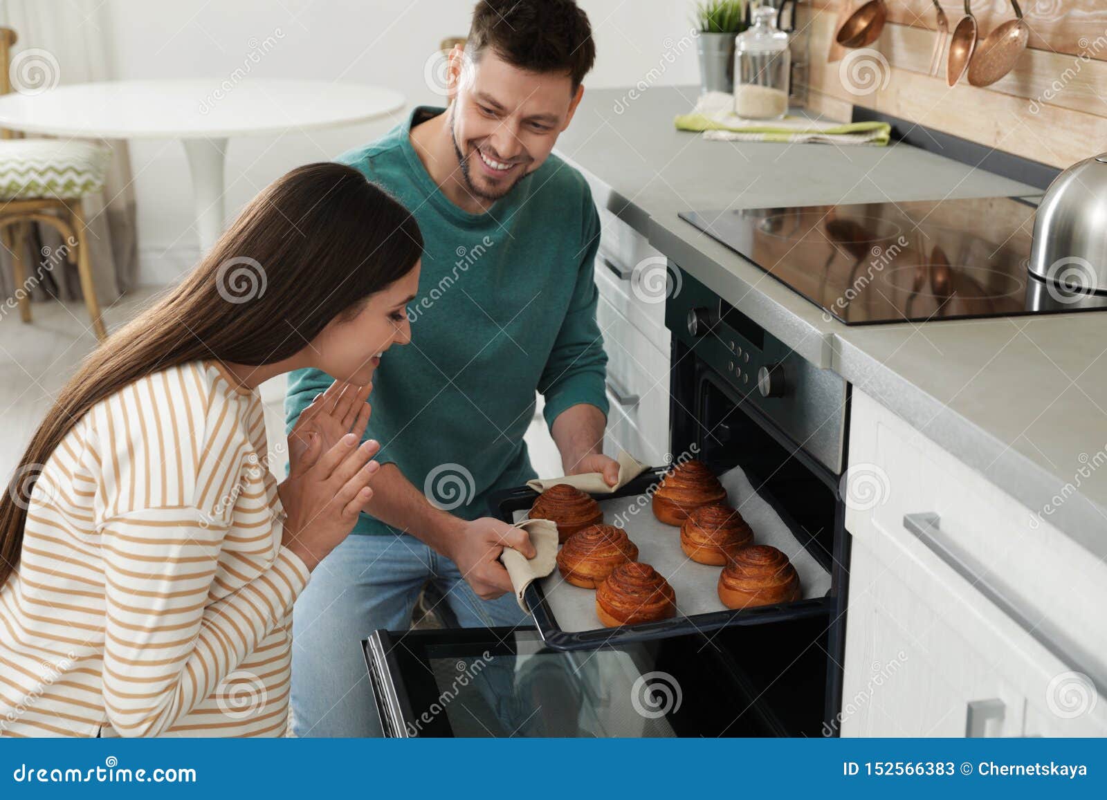 Couple baking buns in oven stock image. Image of home - 152566383
