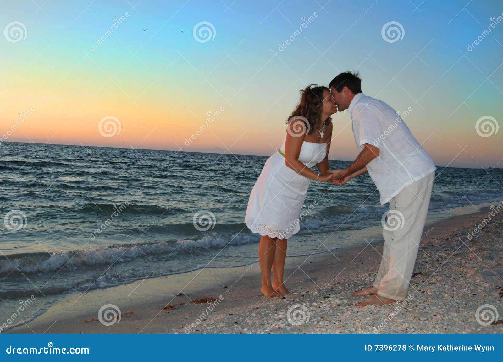 Couple on beach kissing stock photo. Image of couple, bridal - 7396278