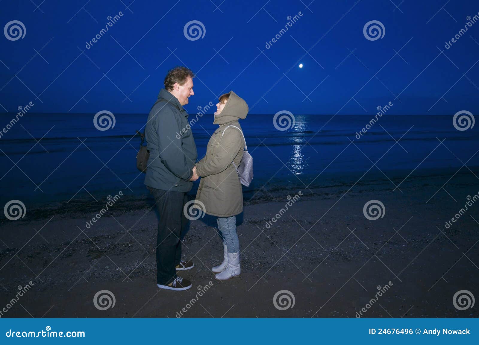 Couple on beach at night stock photo. Image of female - 24676496