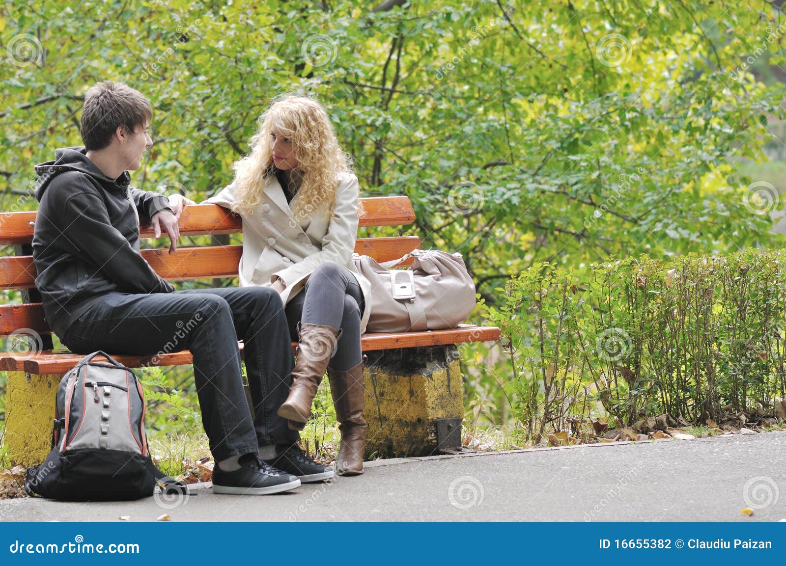 Couple on bench stock photo. Image of outdoors, bush - 16655382