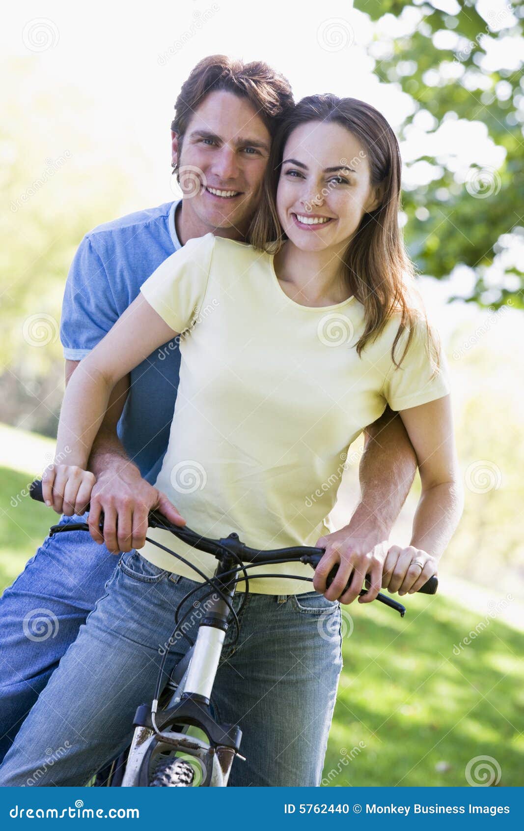 Couple on a Bike Outdoors Smiling Stock Photo - Image of cyclist ...